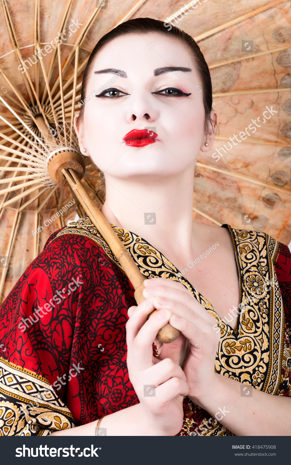 Beautiful Girl Dressed As A Geisha Girl Holding A Chinese Umbrella