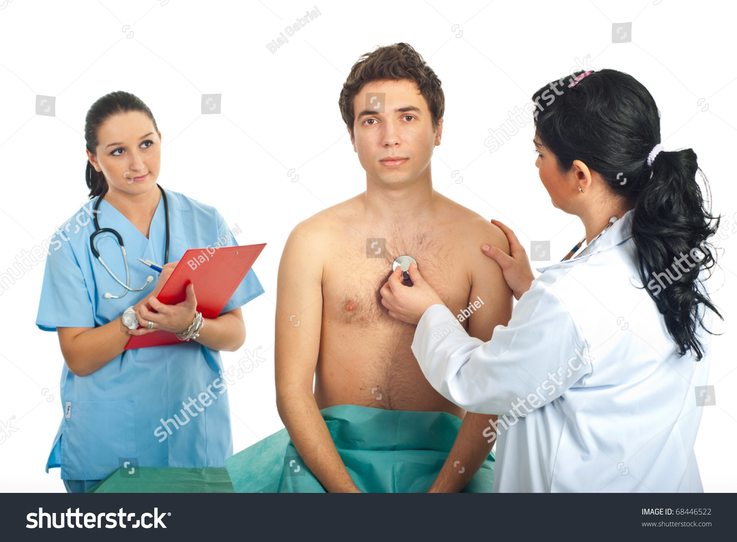 Doctor Woman Examine Young Male Patient While A Nurse Writing In