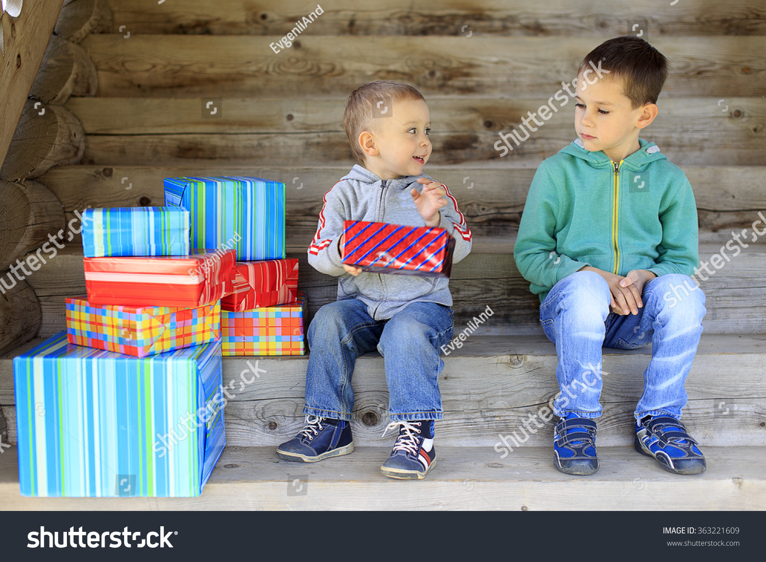 Envious Child. Elder Brother Is Jealous Of A Pile Of Gifts That Are ... Envious Child. Elder Brother Is Jealous Of A Pile Of Gifts That Are ...