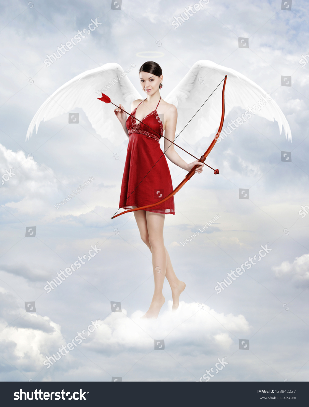 Gorgeous Young Brunette Woman As Cupid Angel In Clouds With White Wings Bow And Arrow Stock