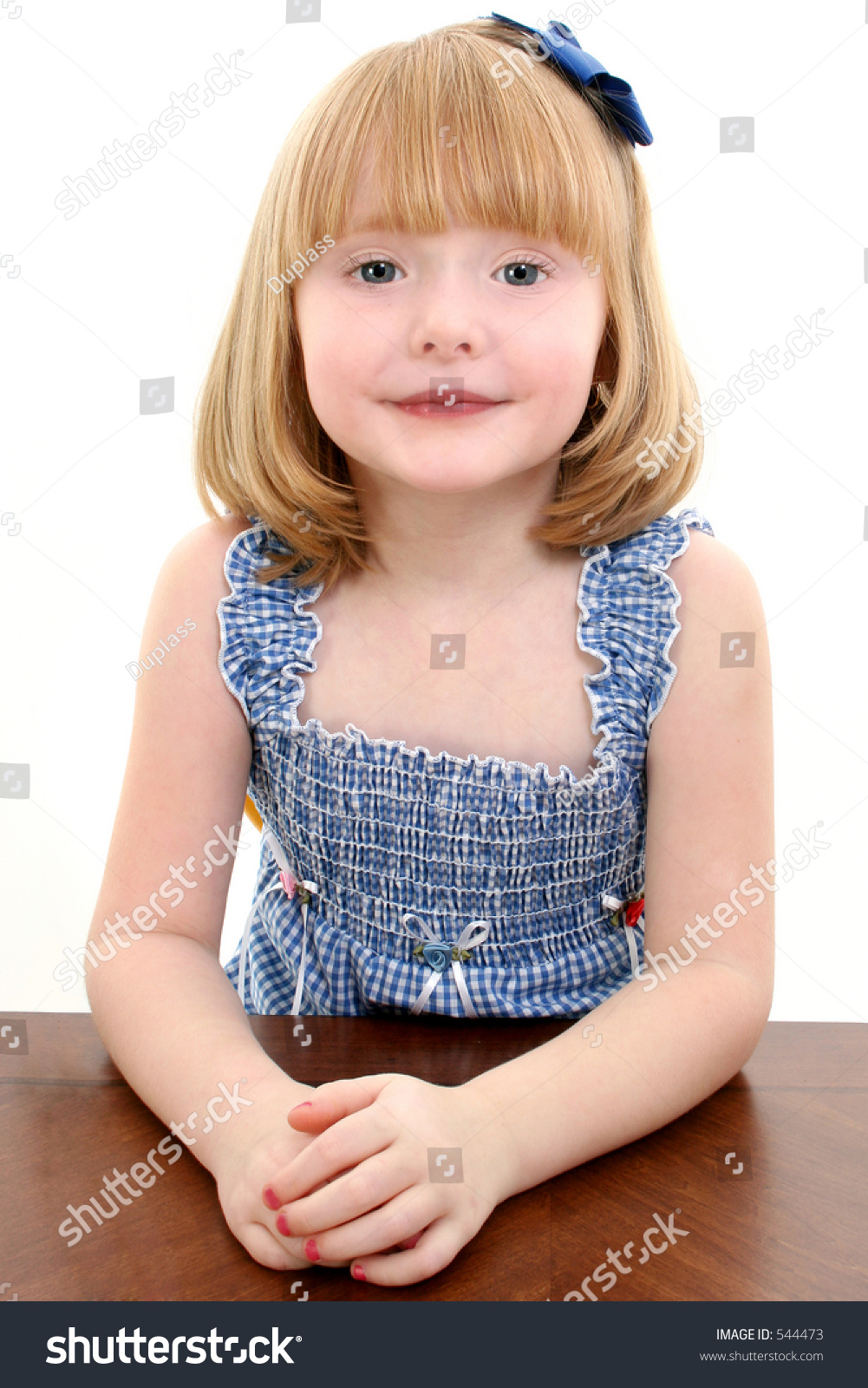 Portrait Of Beautiful 4 Year Old Girl With Strawberry Blonde Hair Sitting At Table Shot In