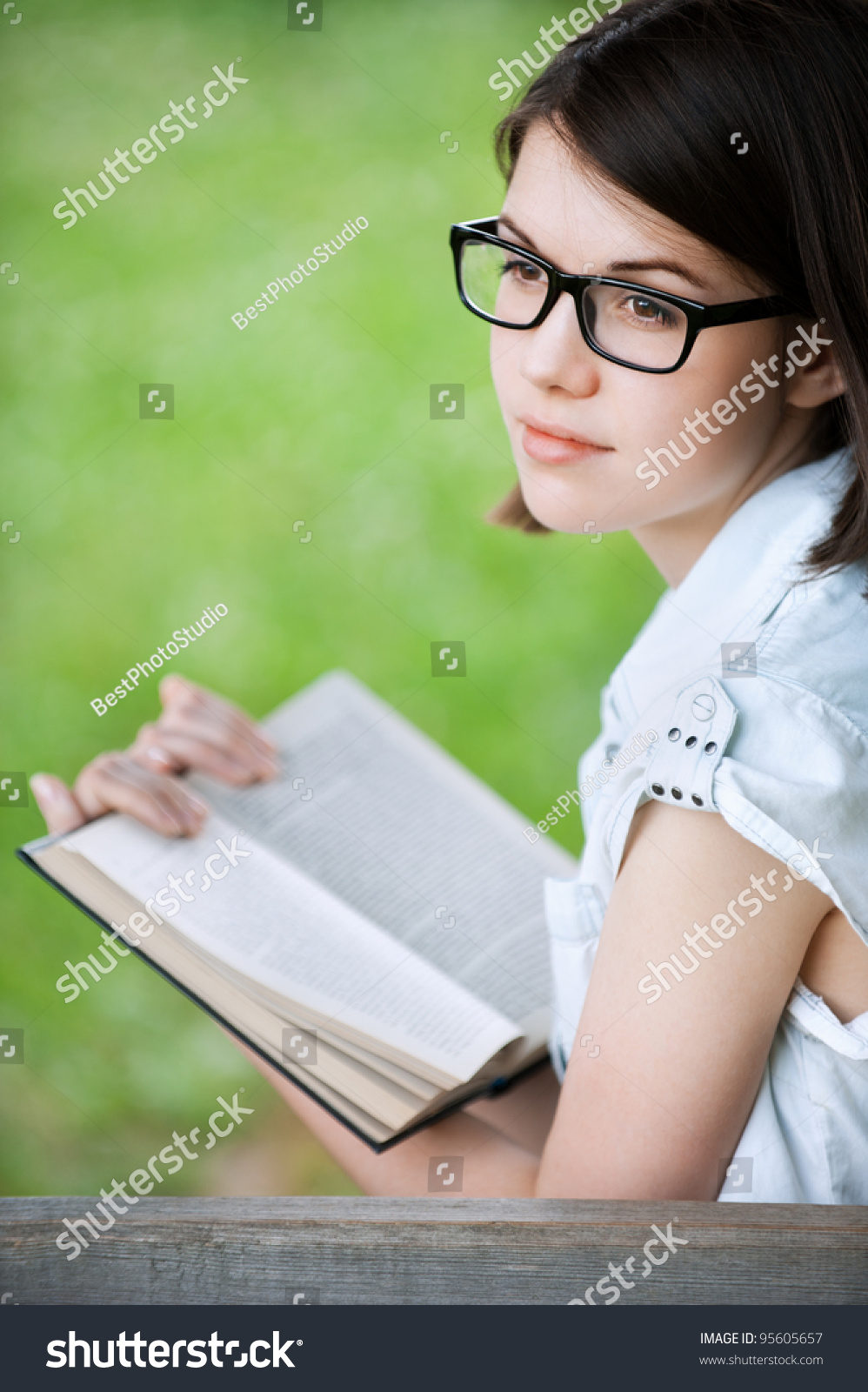 Portrait Of Young Attractive Brunette Woman Wearing Glasses Reading