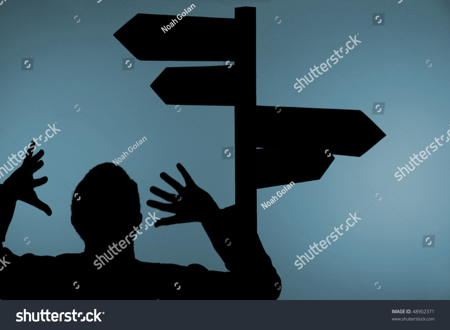 Silhouette Of Confused Man With Hands In Air Under Multiple Directional