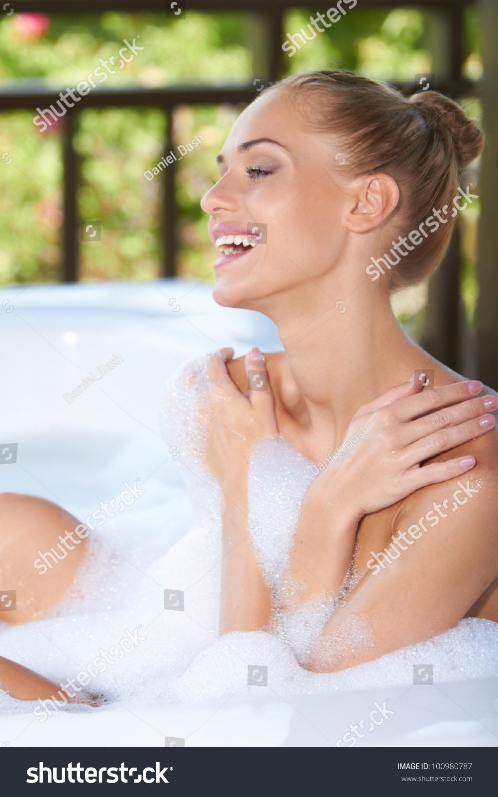 Vivacious Blonde Woman Laughing In Enjoyment As She Soaks In The Soapy