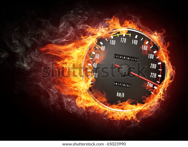 Burning car speedometer enveloped in flame isolated on black background.