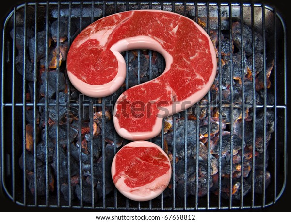 Raw meat in the shape of a question mark, grilling on the barbecue ...
