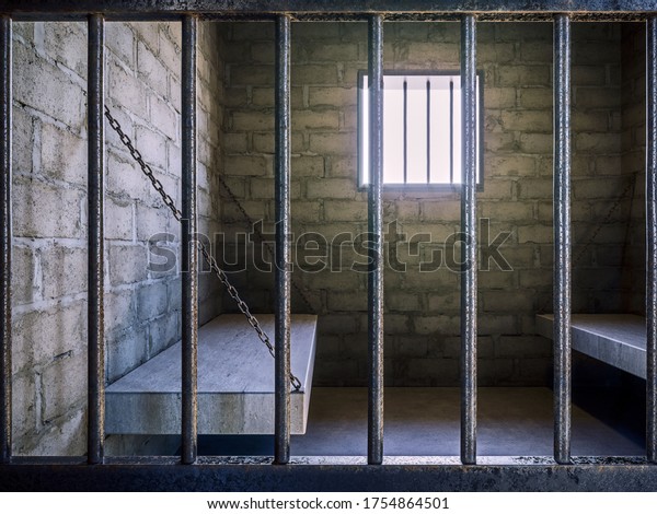 View of the prison cell through bars with sun shining through the ...