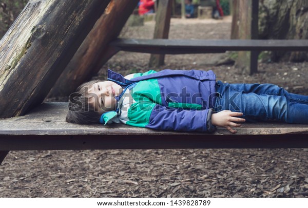 Active Child Lying Down On Wooden Stock Photo 1439828789 | Shutterstock