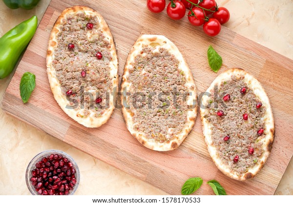 Arabic flat bread with meat. Meat with dough, manaqesh meat. Top view