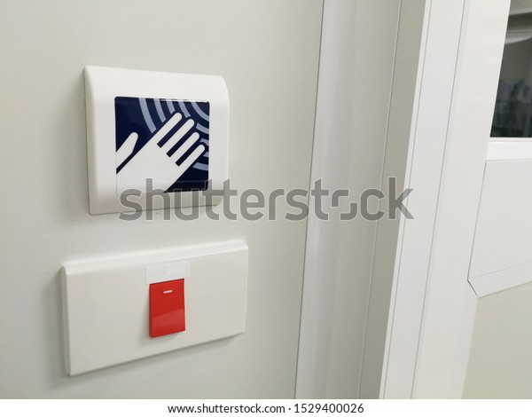 Automatic door button with Red light switch in Operating Room at Hospital.