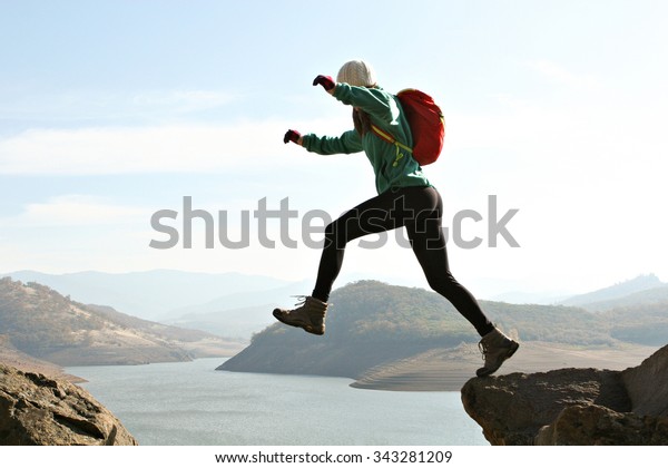 Backpacker Stepping Over Large Gap Mountains Stock Photo (Edit Now ...