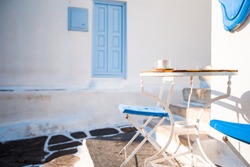 Outdoor cafe on a street of typical greek traditional village in greece ...