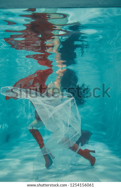 Beautiful Sexy Girl Swimming Underwater In Sporty Style Red And White Fetish Corset And Over
