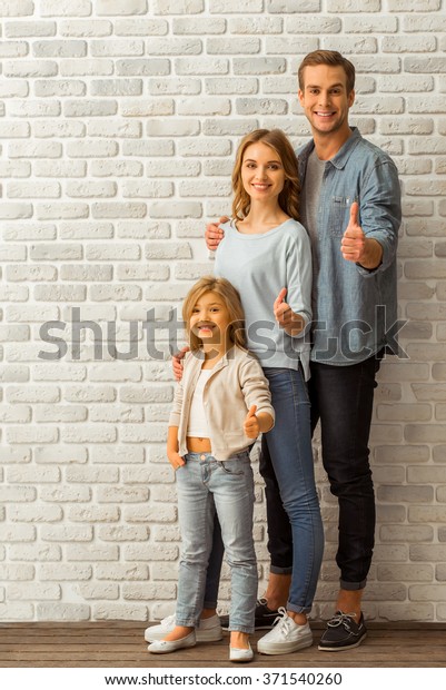Beautiful Young Family Looking Camera Smiling Stock Photo (Edit Now ... Beautiful Young Family Looking Camera Smiling Stock Photo (Edit Now ...