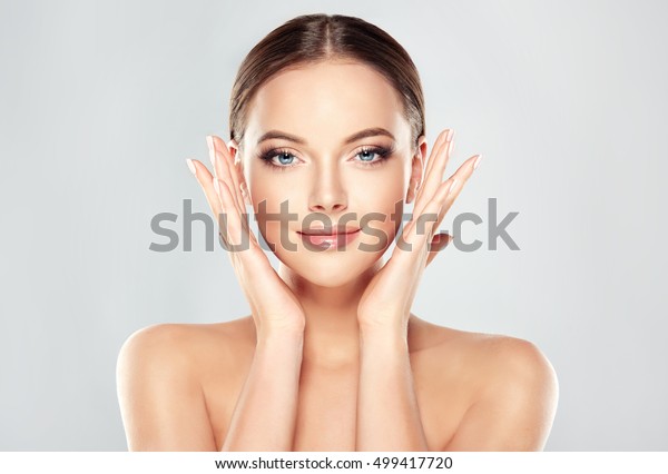 Beautiful Young Woman with Clean Fresh Skin touch own face . Facial ... Beautiful Young Woman with Clean Fresh Skin touch own face . Facial ...