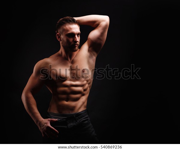 Bodybuilder Posing On Black Background Dramatic Stock Photo 540869236 ...