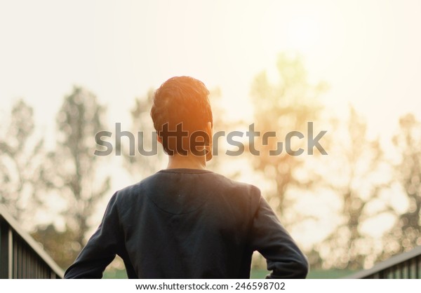 Boy Facing Back Looking Towards Sunset Stock Photo (Edit Now) 246598702