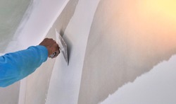 Handy man working in the house featuring building, plastering, and ...