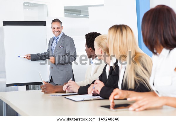 Businesspeople Looking Businessman Explaining Presentation Stock Photo ... Businesspeople Looking Businessman Explaining Presentation Stock Photo ...