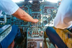 Airplane cockpit thrust levers with hand on top for takeoff containing ...