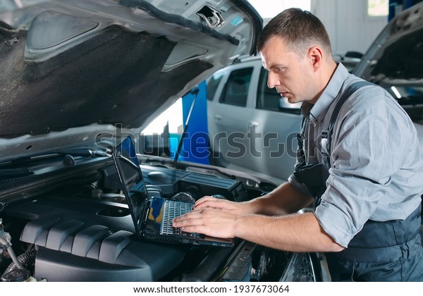 Car Mechanic Using Computer Laptop Diagnosing Stock Photo 1937673064 ...