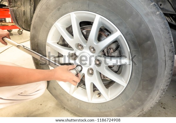 Car Mechanic Using Tools Remove Wheel Stock Photo (Edit Now) 1186724908