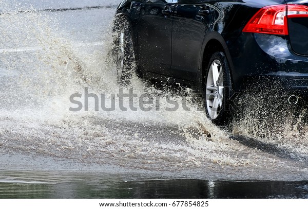 Car Splashes Through Large Puddle On Stock Photo 677854825 | Shutterstock