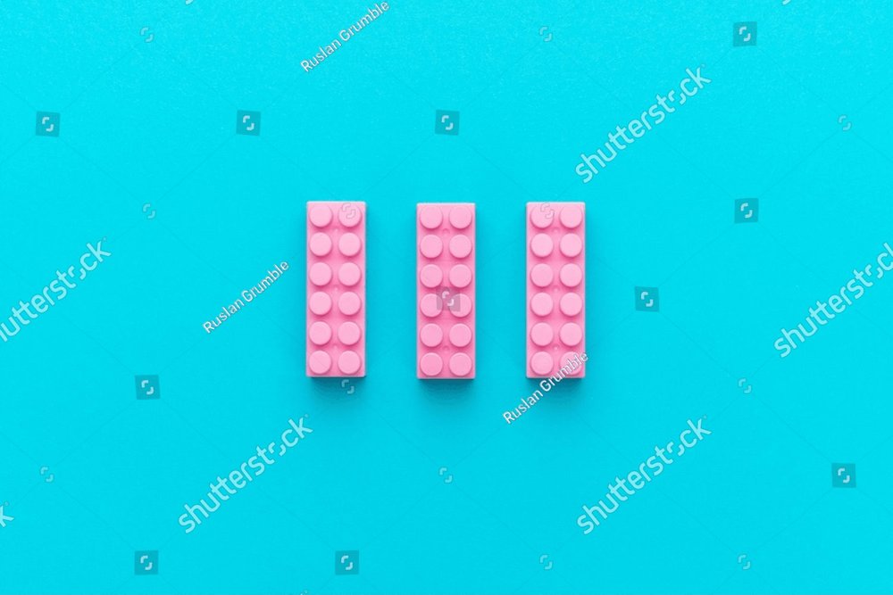 Central composition of three plastic building blocks on turquoise blue ...
