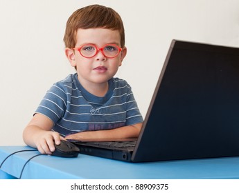 Стоковая фотография 86880259: Smiling Child Glasses Using Computer ...