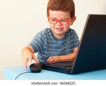 Стоковая фотография 86880259: Smiling Child Glasses Using Computer ...