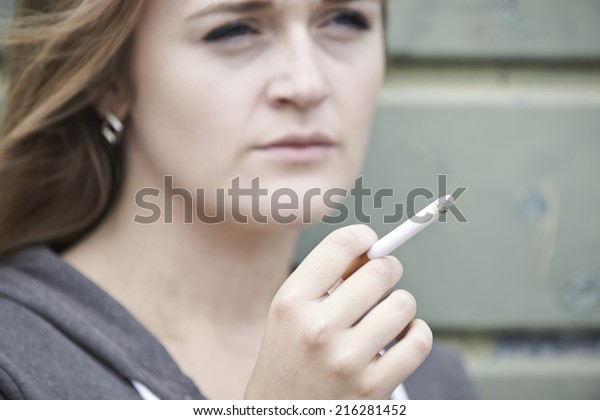 Close Up Of Teenage Girl Smoking Cigarette Outdoors Close Up Of Teenage Girl Smoking Cigarette Outdoors