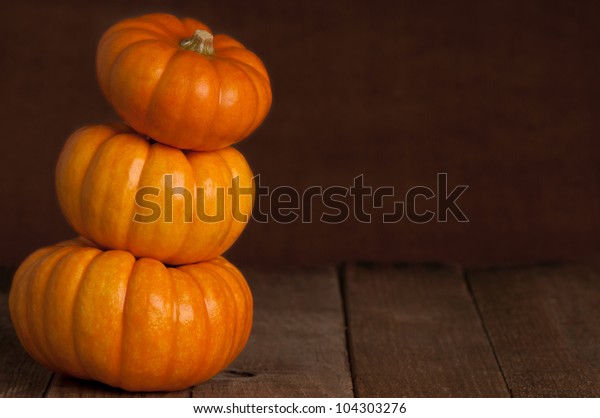 Close Three Small Pumpkins Stacked On Stock Photo (Edit Now) 104303276