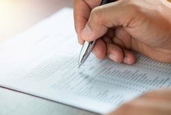 Businessman using the pen to reviewing or checking the Curriculum Vitae ...