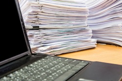 Documents on desk stack up high featuring document, desk, and pile, a ...