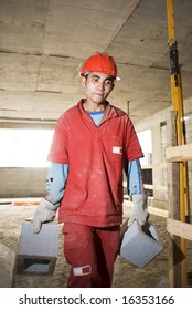 Construction Worker Carries Two Cinder Blocks Stock Photo 16353166 ...