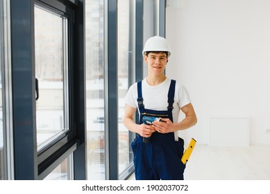 Стоковая фотография 2117622839: Workman Overalls Installing Adjusting ...
