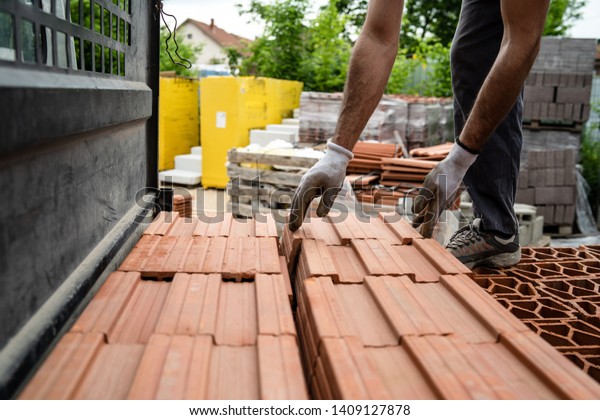 Construction worker loading material in the lorry truck at the ...