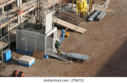 Construction Worker Pulling Cart Into Elevator Stock Photo 2706713 ...