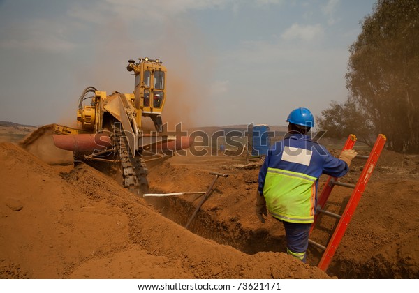 Construction Worker Watching Trencher Machine Digging Stock Photo (Edit ...