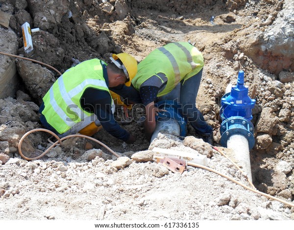 Construction Workers Install Underground Utility Services Stock Photo ...