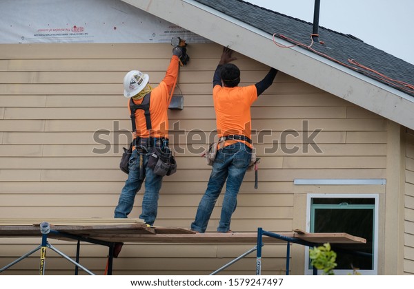 Construction Workers Installing Vinyl Siding Facade Stock Photo (Edit ...