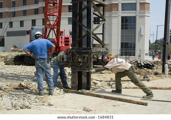 Construction Workers Positioning Pile Driver Stock Photo (Edit Now) 1684831