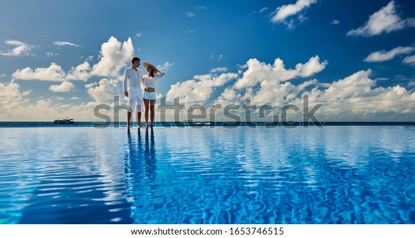 Couple Infinity Pool Poolside Against Sky Stock Photo 1653746515 ...