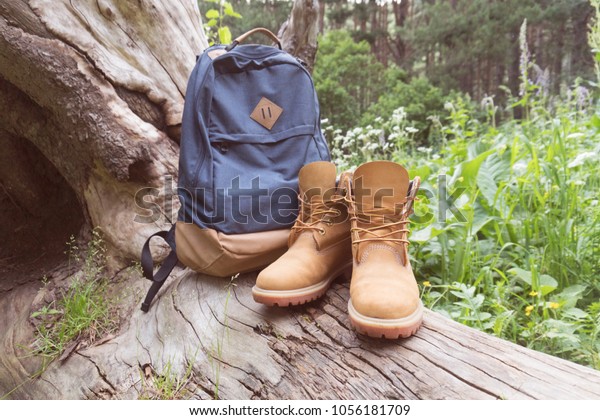 Стоковая фотография 1056181709: Creative Layout Backpack Leather Boots ...