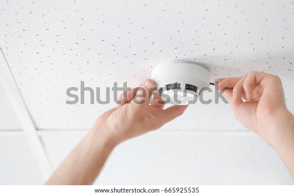 Electrician Installing Smoke Detector On Ceiling Stock Photo 665925535 ... Electrician Installing Smoke Detector On Ceiling Stock Photo 665925535 ...