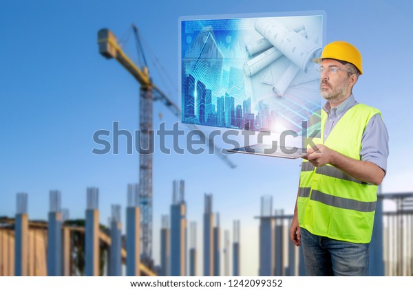 Engineer Holding Tablet Displaying Construction Plans Stock Photo ...