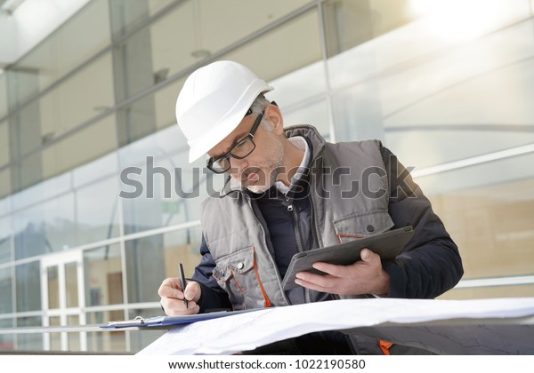 Engineer On Site Checking Project On Stock Photo (Edit Now) 1022190580