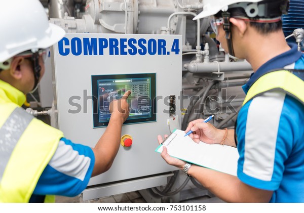 Engineers control in machine room and looking to monitor of compressor ...