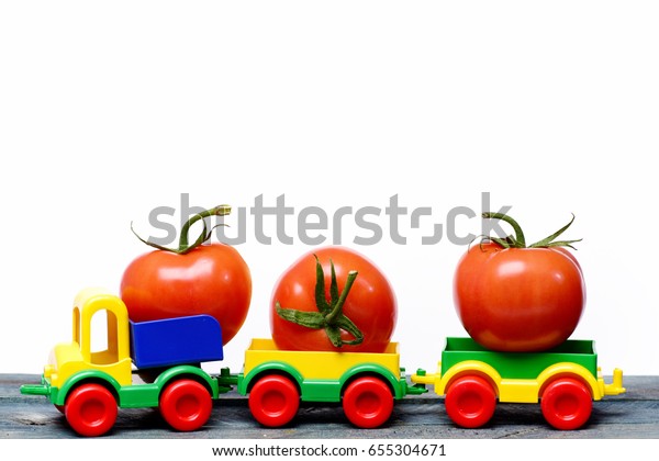 export concept, red tomatoes in plastic lorry car toy isolated on white ...