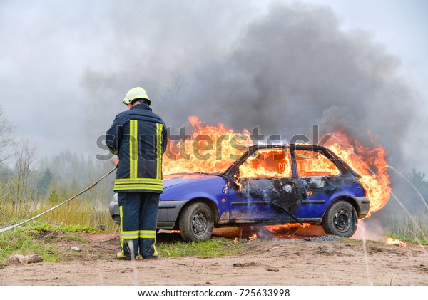 Fire fighter prepare to attack a propane fire. Abandoned burning and ...